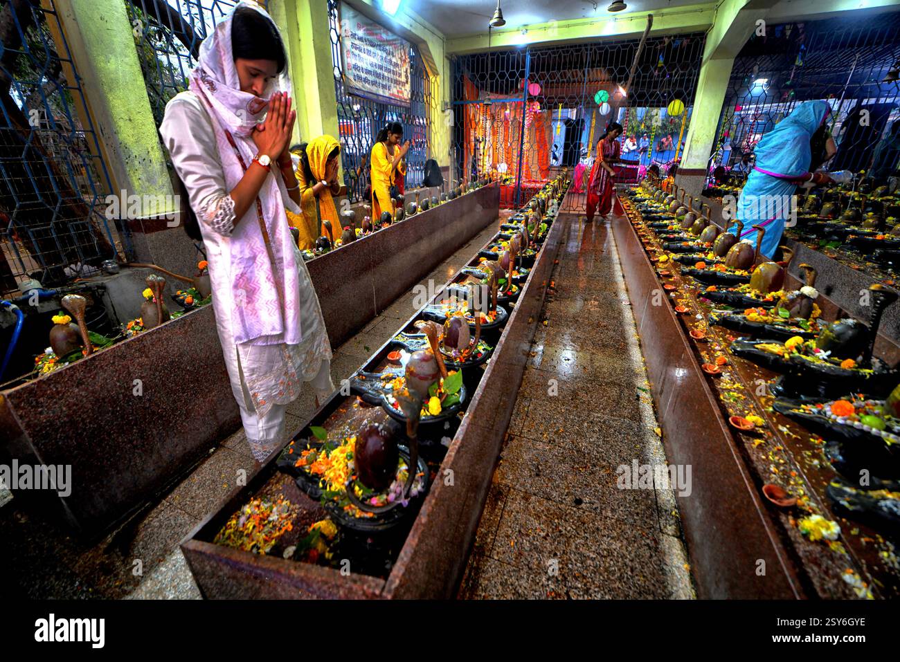 Devotees offer prayer to the Shivling at 111 Shivling's (a symbol of ...