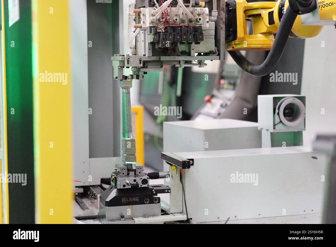 HARBIN, Feb. 27, 2025 -- A robotic arm operates at a smart production ...
