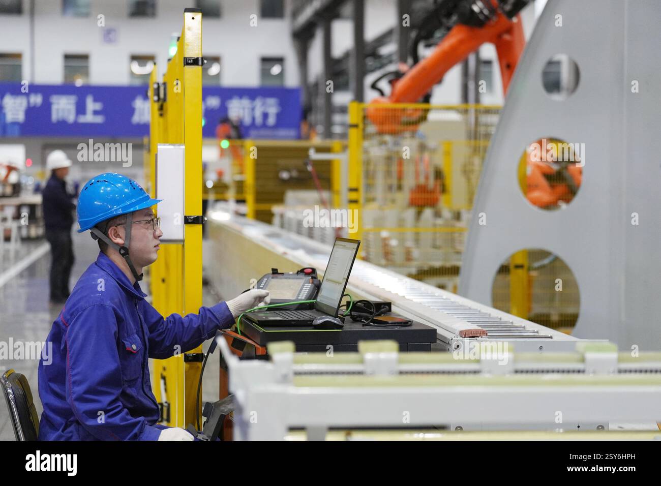 HARBIN, Feb. 27, 2025 -- A staff member operates digitally controlled ...