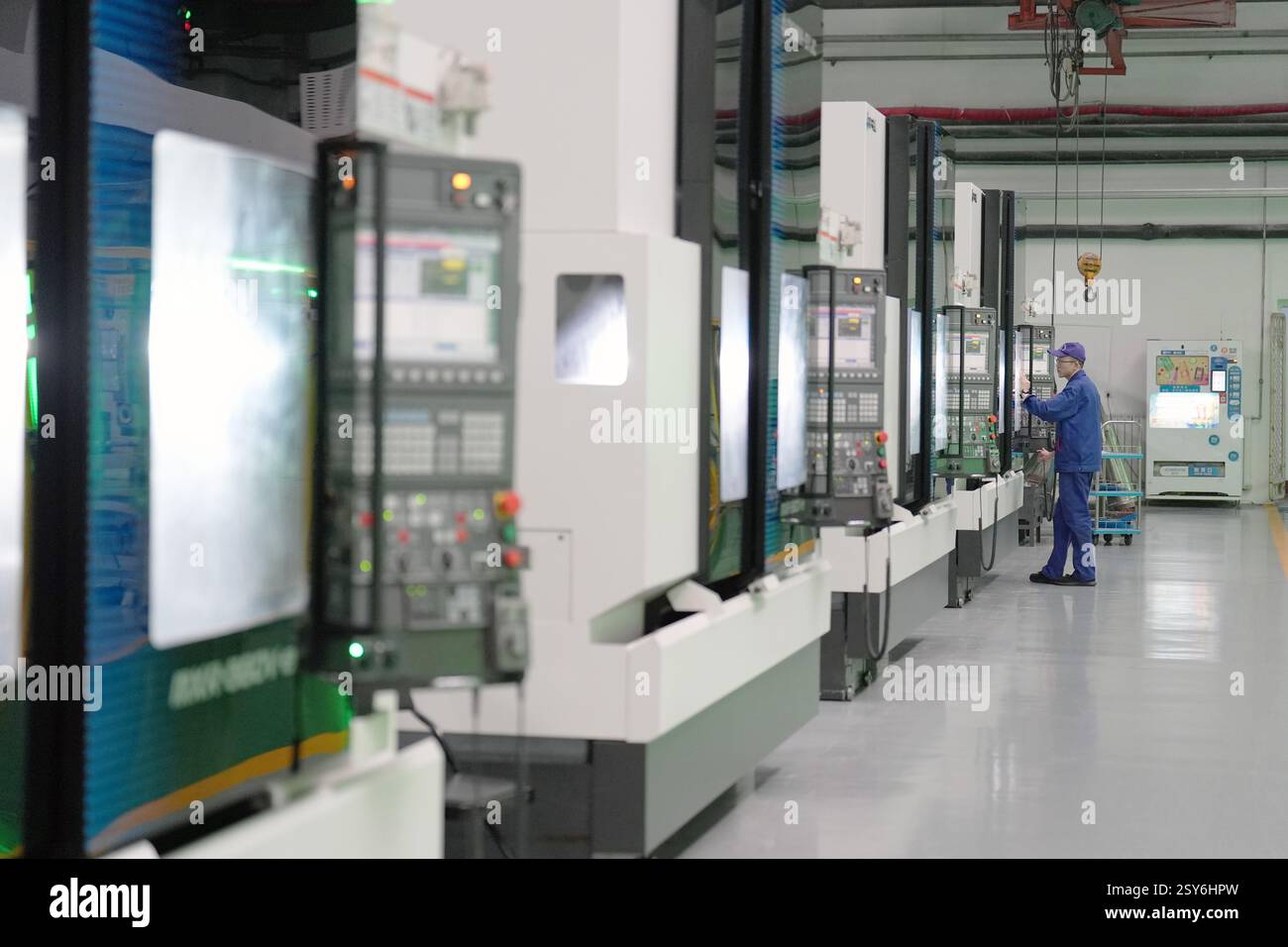 HARBIN, Feb. 27, 2025 -- A staff member operates digitally controlled ...