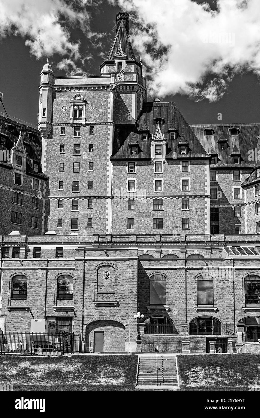 Large brick building with a steeple. The building is black and white ...