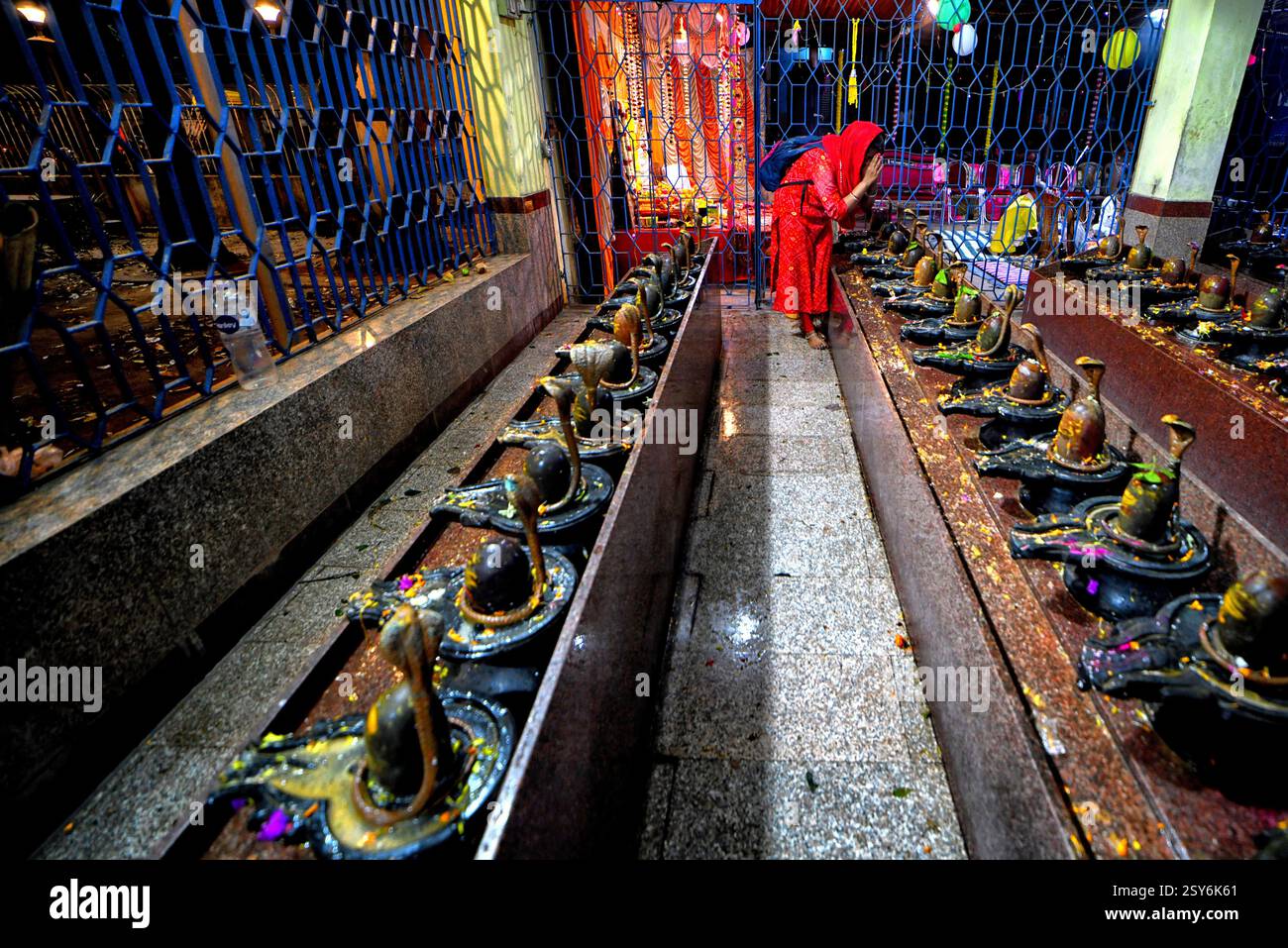 A devotee seen offering Prayer to the Shivling at 111 Shivling's (a ...