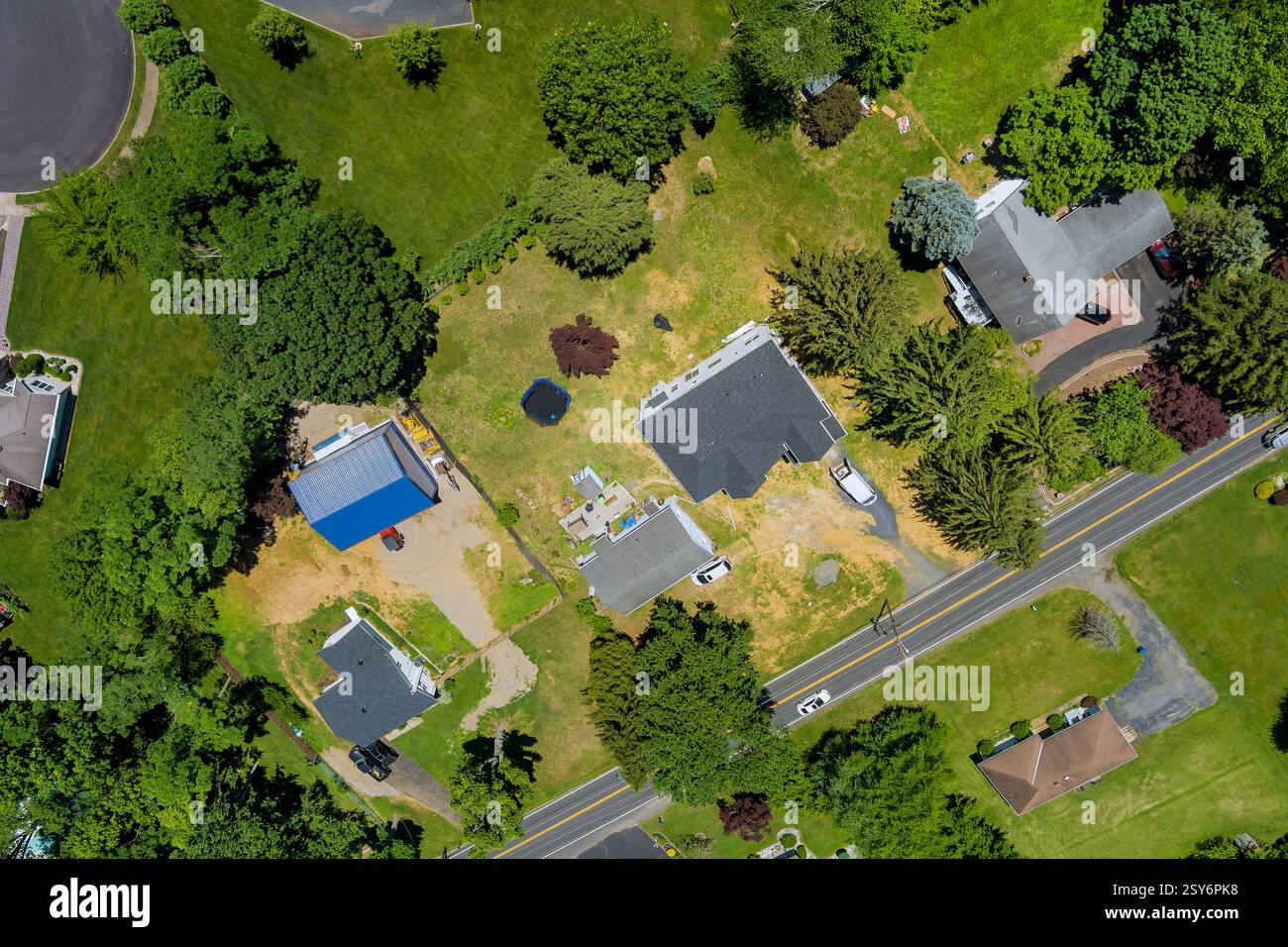 Aerial view of several homes in lush suburban setting showcasing lawns ...