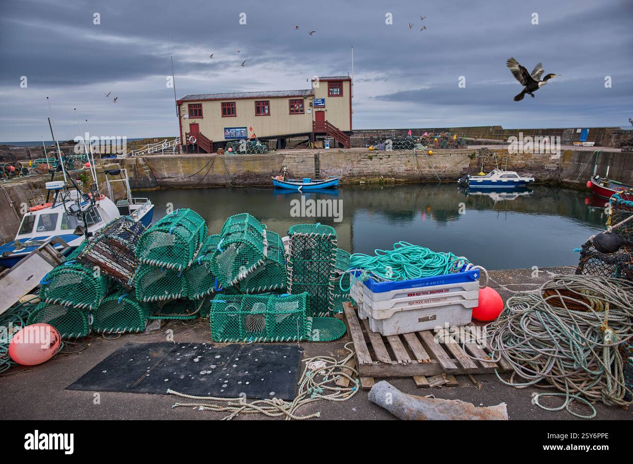 Colour photo of the harbour and lifeboat station of the small fishing ...