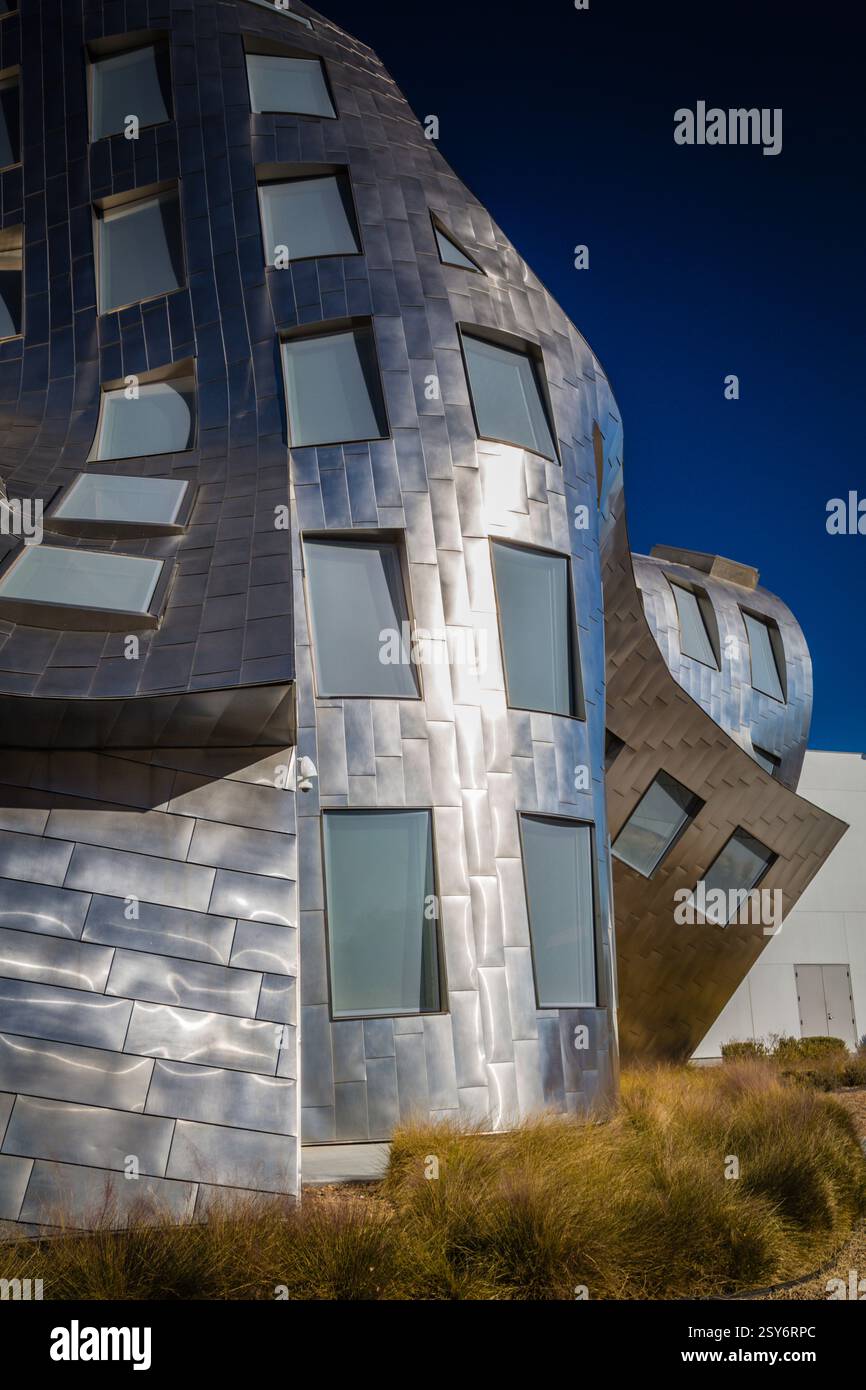 The building is a large, modern structure made of metal and glass. It ...