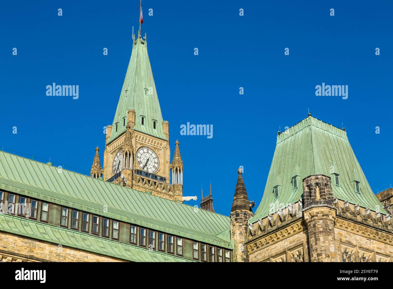 Clock tower with a green roof and a clock on the front. The clock is on ...