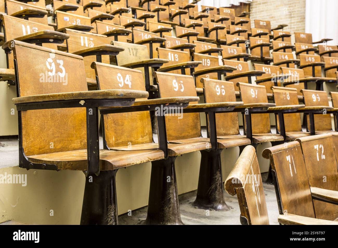 Row of wooden chairs numbered from 1 to 93. The chairs are empty Stock ...