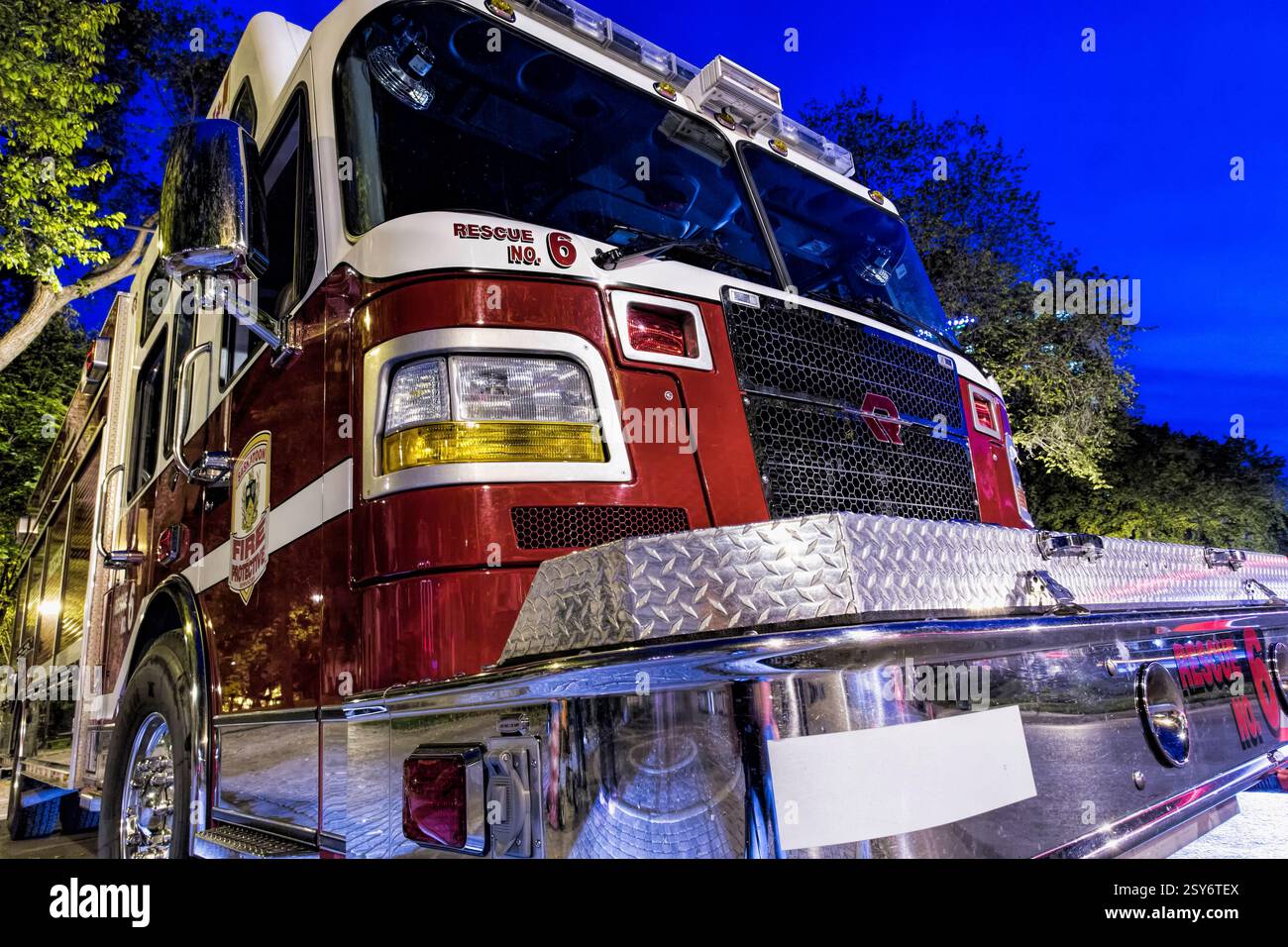 Red and white fire truck with a white stripe. The truck is parked on ...