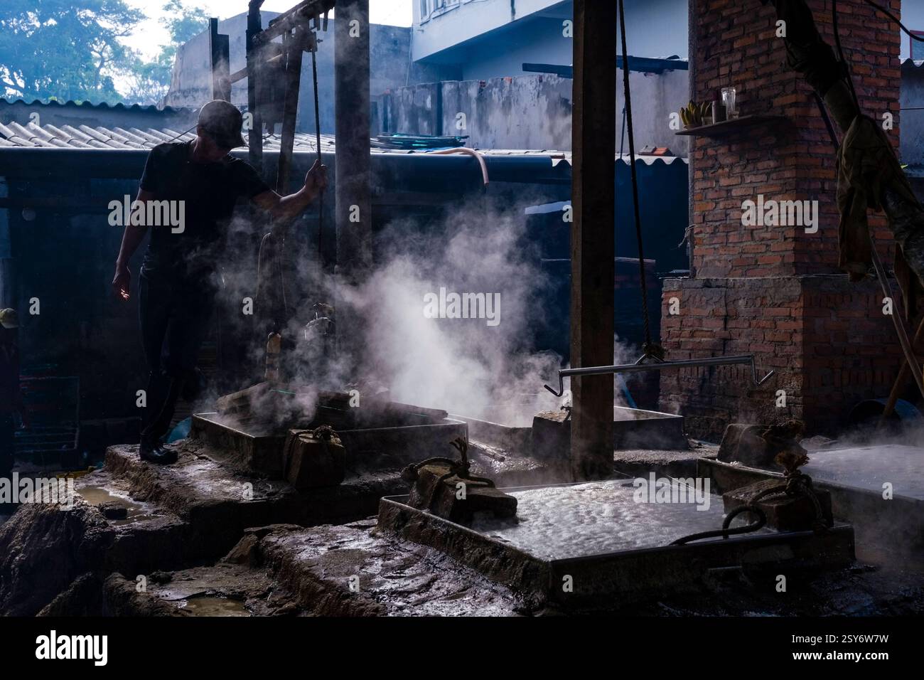 Small fish are cooked before drying them on simple grates on the beach ...