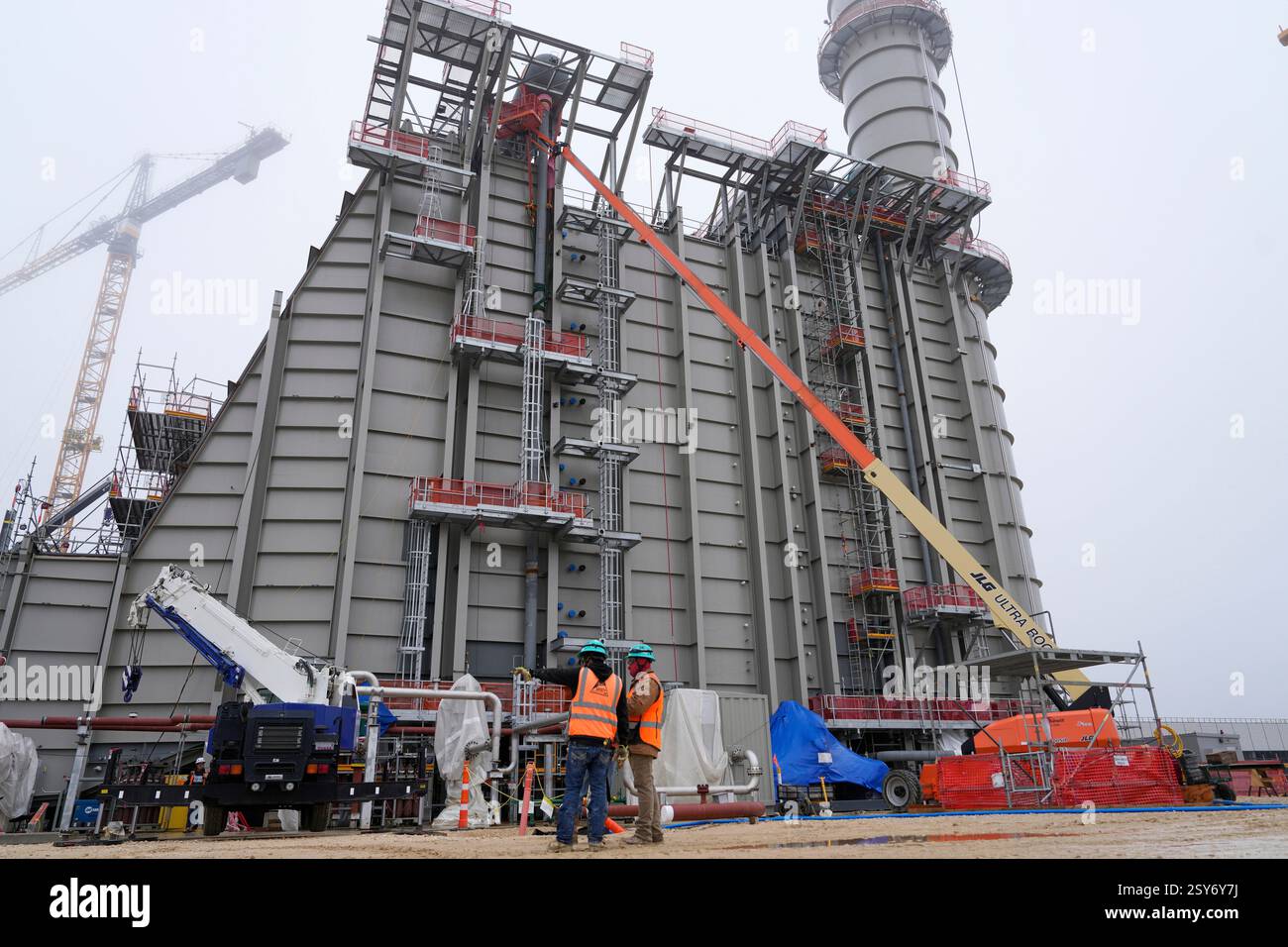 Workers talk at Entergy's Orange County Advanced Power Station, a 1,215 ...