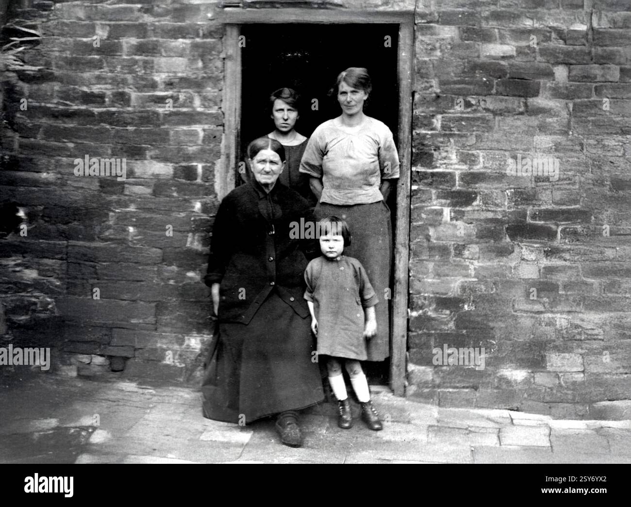Poor working class women mother, daughters and grand daughter in slum ...