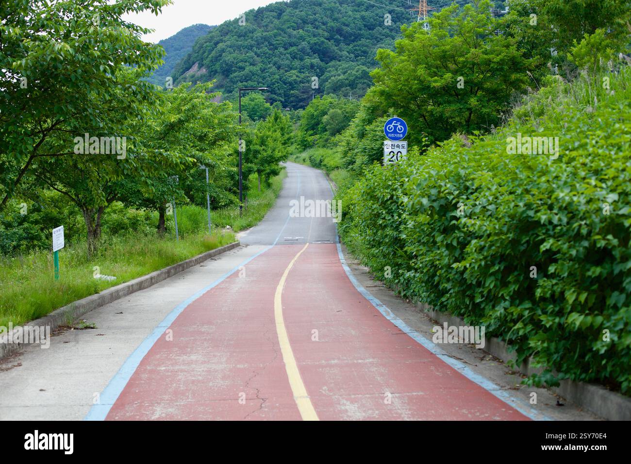 Sejong City, South Korea - May 27, 2021: A red cycling path winds ...