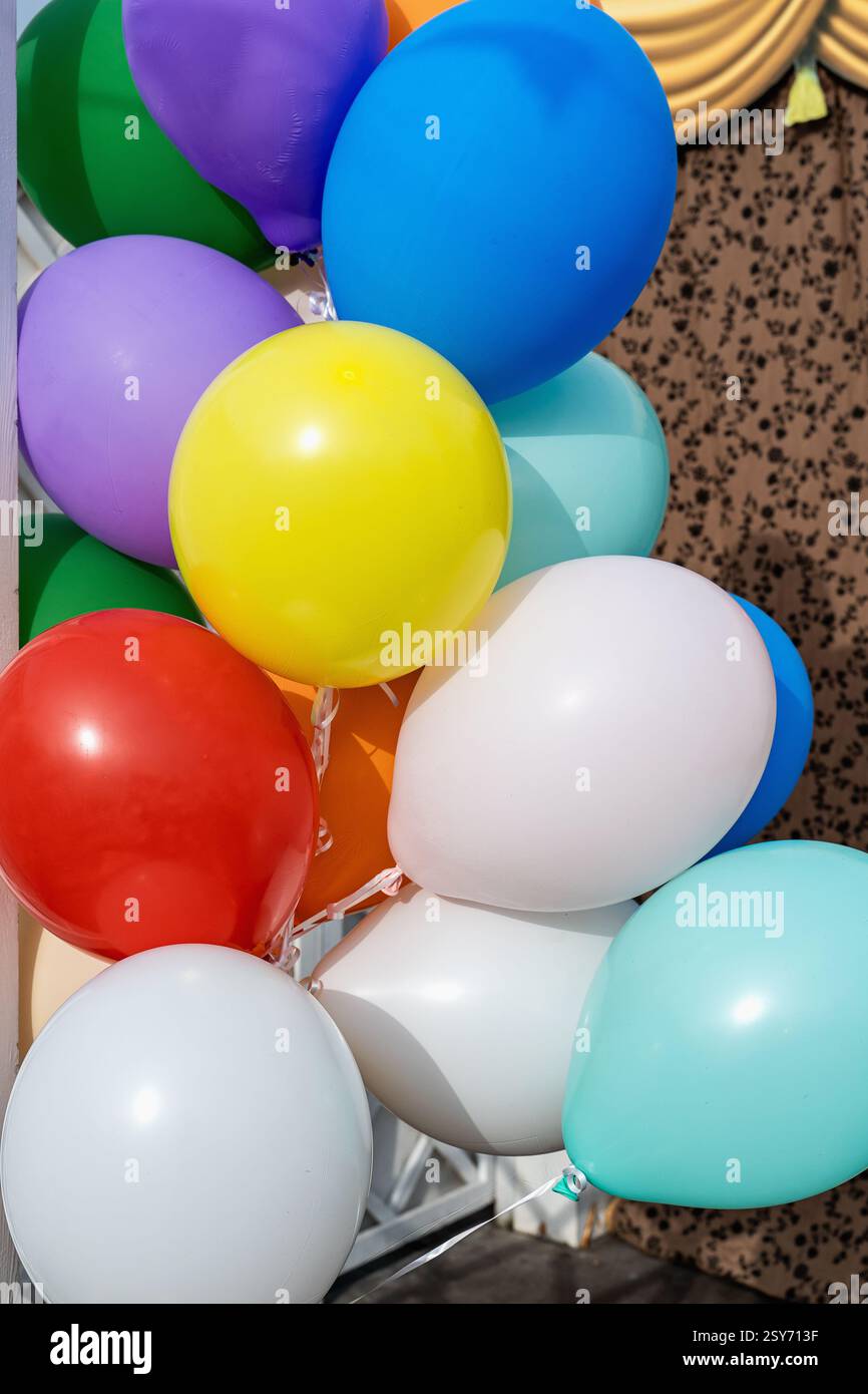 set of multi-coloured balloons rises on an artistic background ...