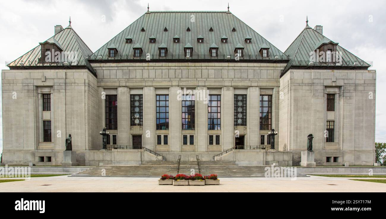 Large building with a green roof. The building has a clock tower. There ...
