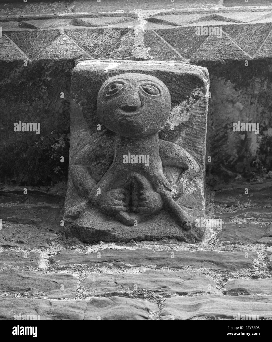 A crude 12th century medieval stone carving of a gargoyle known as a ...