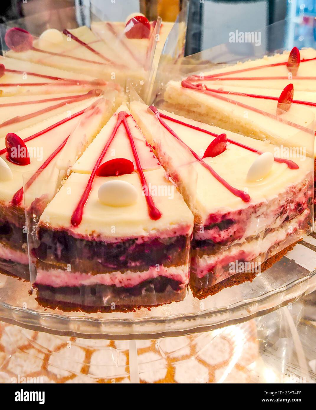 Triangular slices of cherry cake drizzled with white chocolate ...