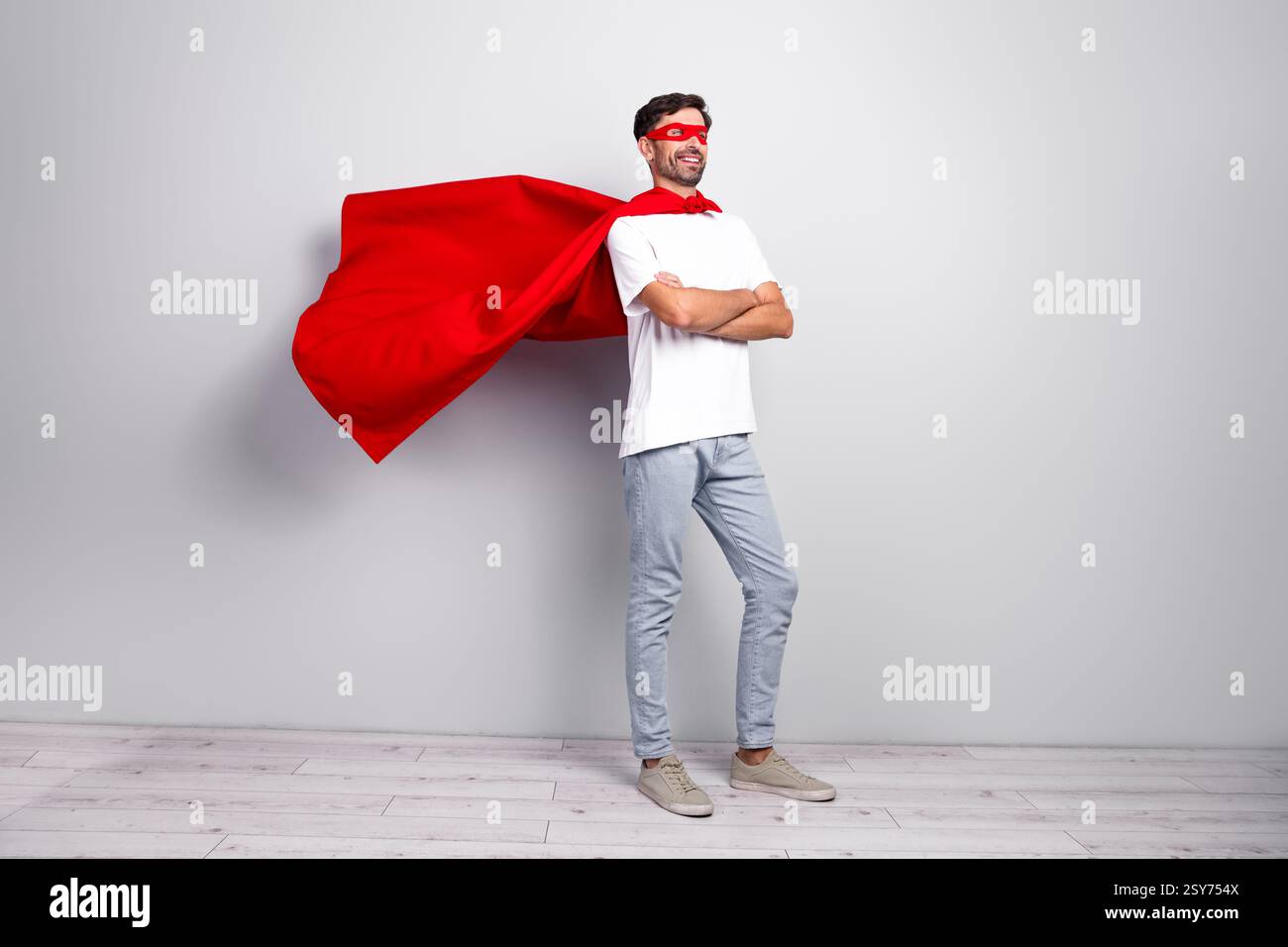 Confident Man Dressed as a Superhero in Casual Attire Standing Against ...