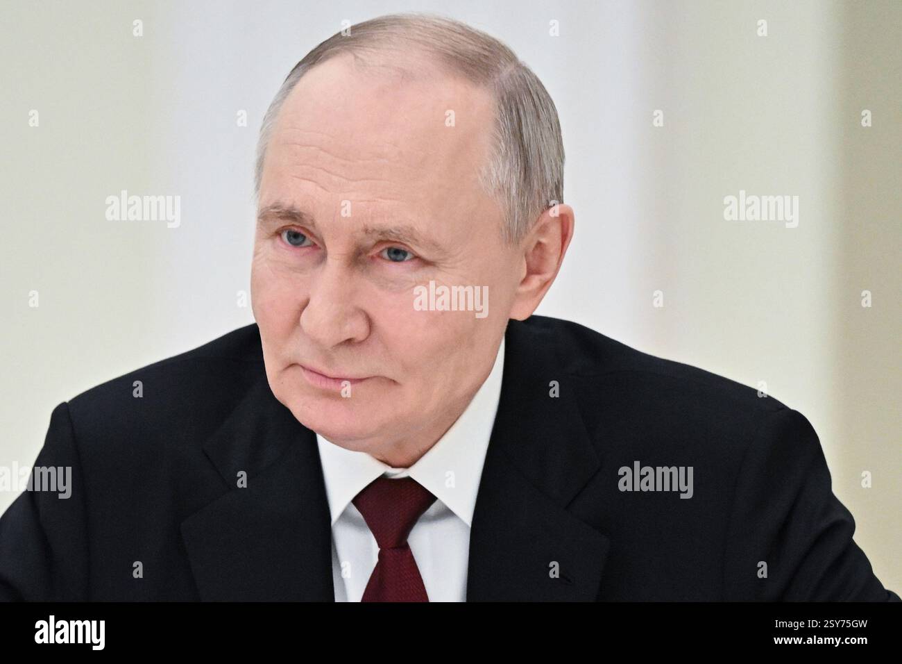 Russian President Vladimir Putin listens to the member of the Politburo ...