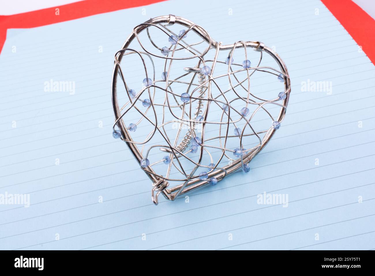 Heart cage on a lined background Stock Photo - Alamy