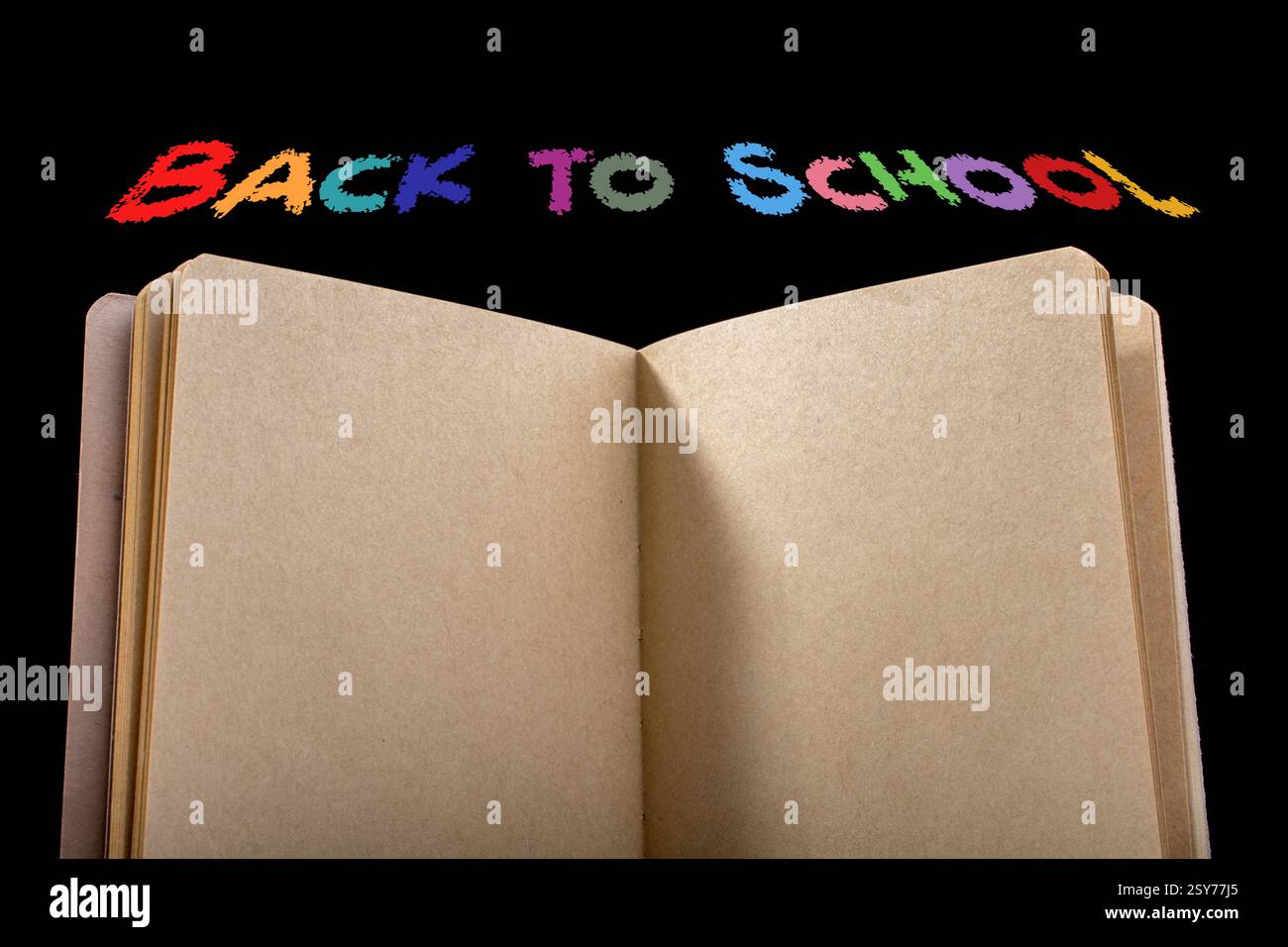 Brown color notebook open on a black background Stock Photo - Alamy