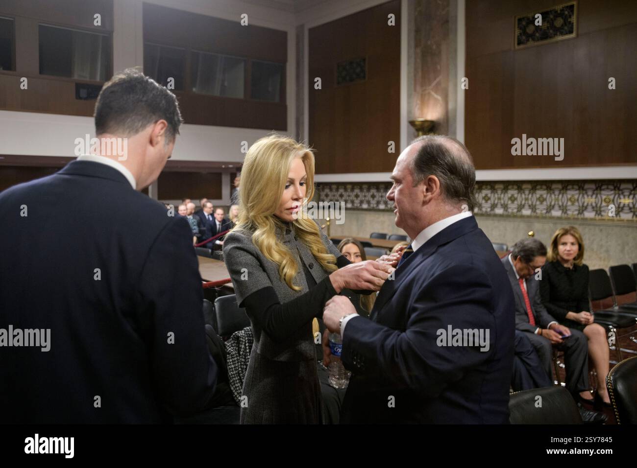 Amy Phelan, center, helps her husband John Phelan, right, President ...