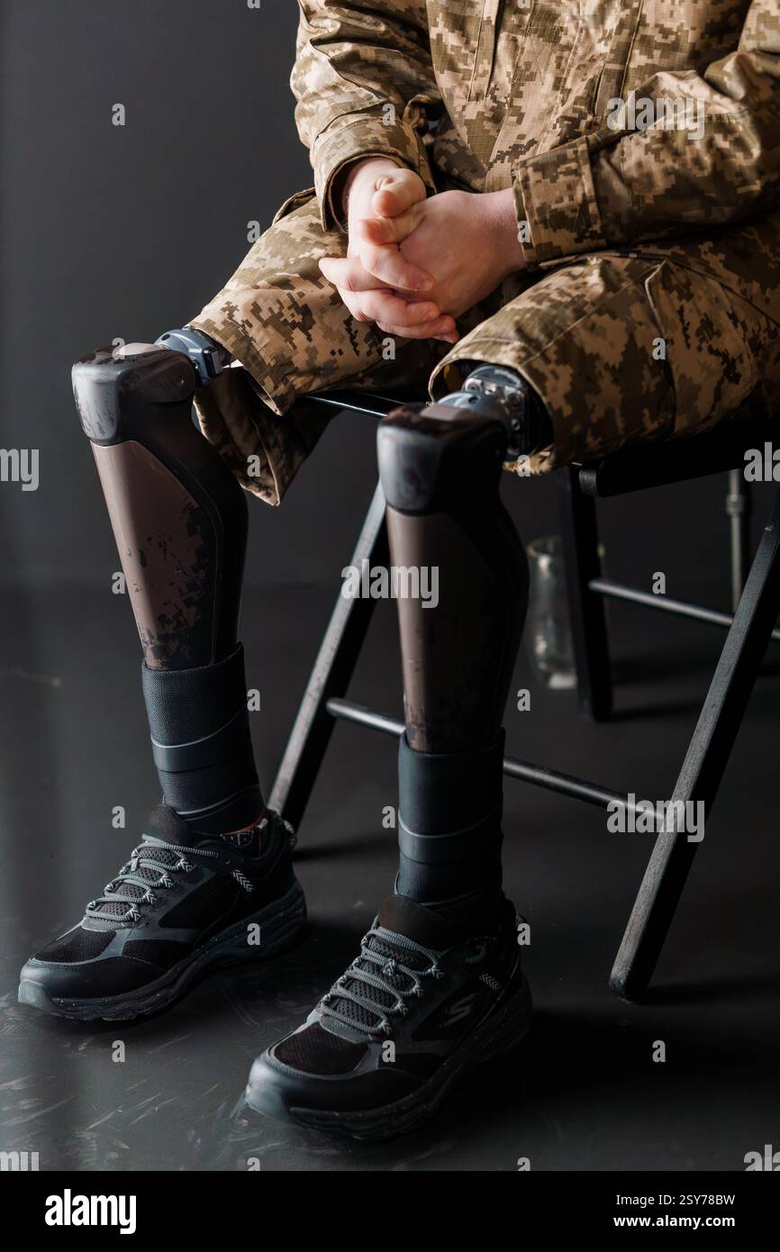 A Soldier Sitting with Advanced Bionic Leg Prosthesis in Tactical ...
