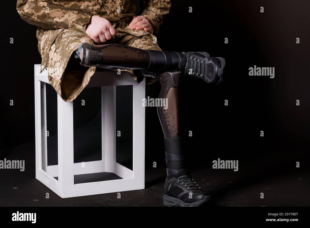 Soldier Seated with Advanced Bionic Leg Prosthesis, Showcasing Modern ...