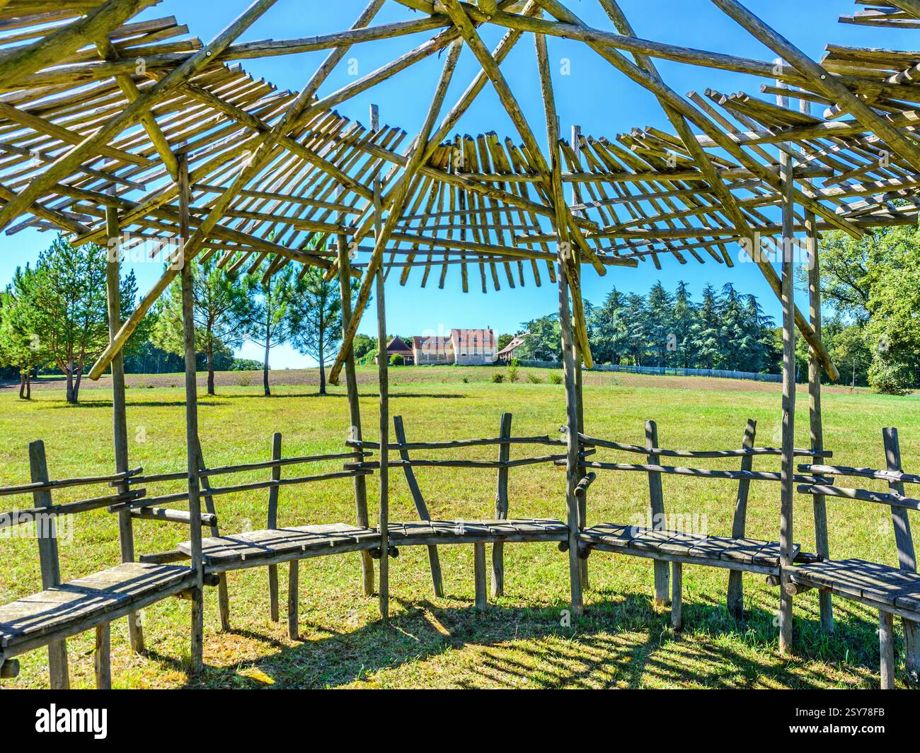 Rustic wooden seating and picnic area on hillside above the village of ...