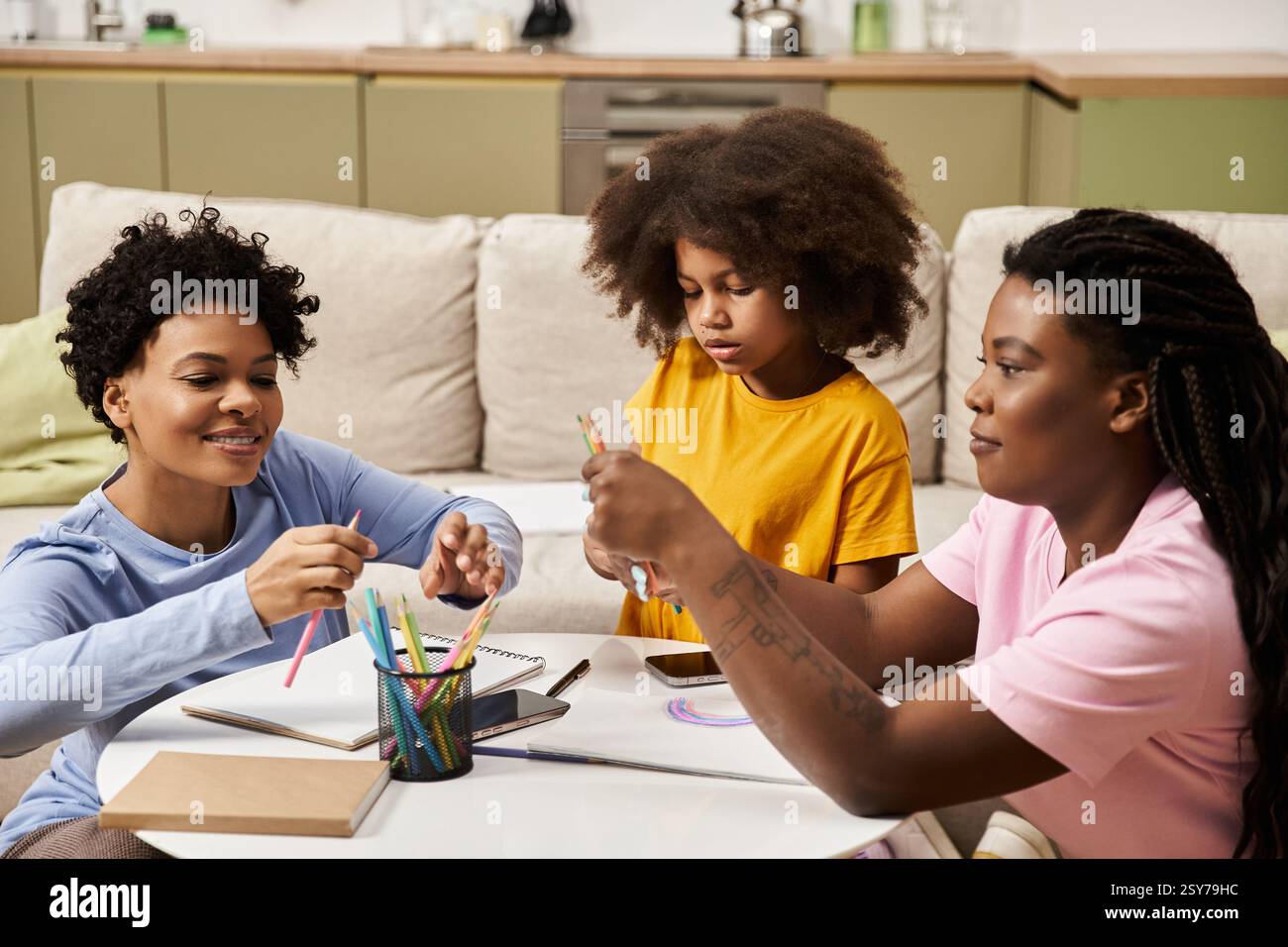 Parents and daughter enjoy crafting together in their cheerful home ...