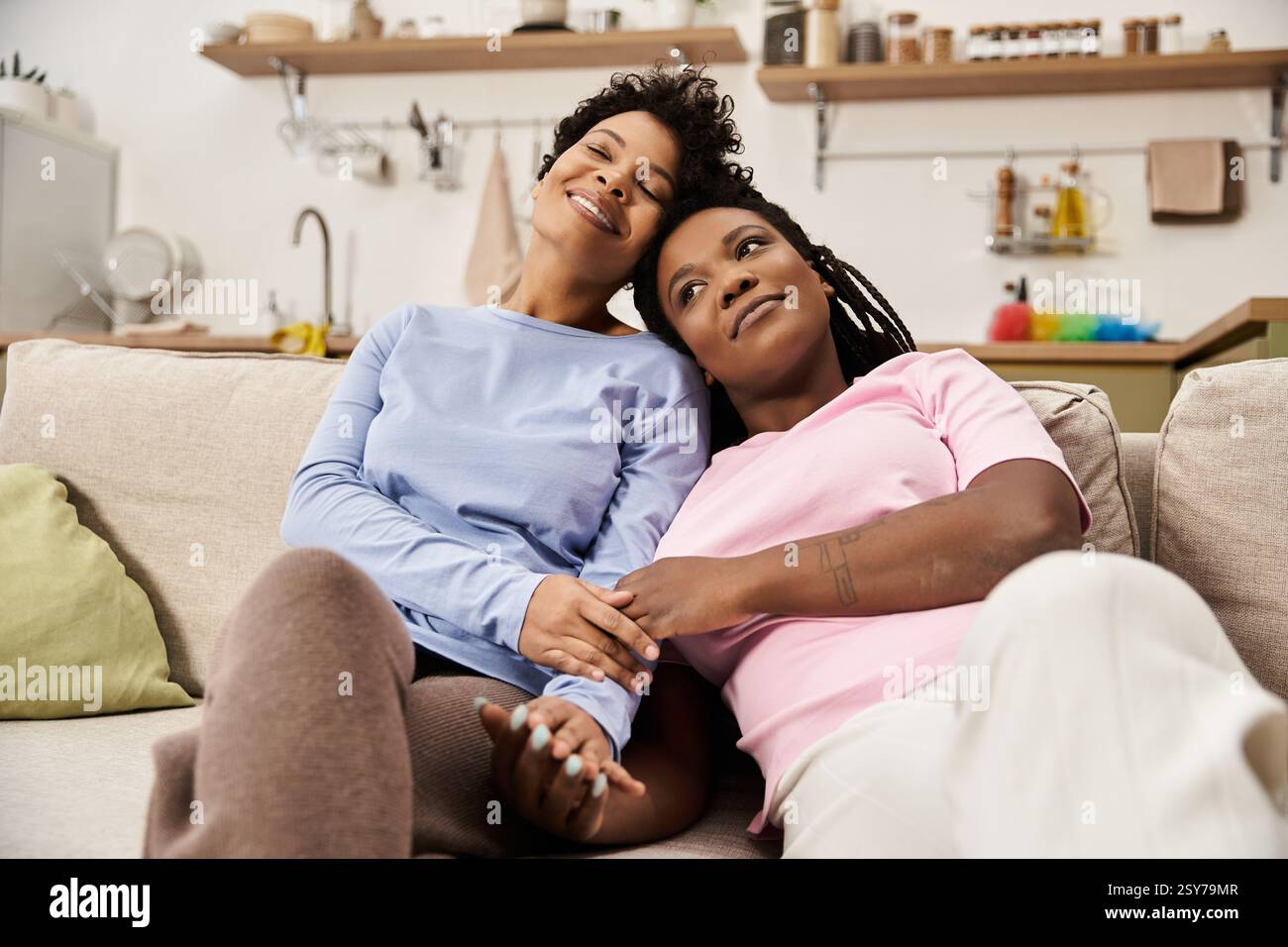 Two women enjoy a warm and tender moment together, showcasing love and ...
