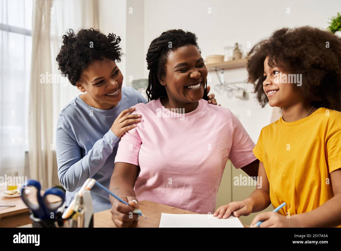 Three family members share smiles while engaging in a fun and creative ...
