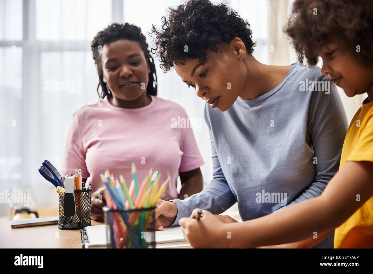 Family members engage in a fun art activity, fostering creativity and ...