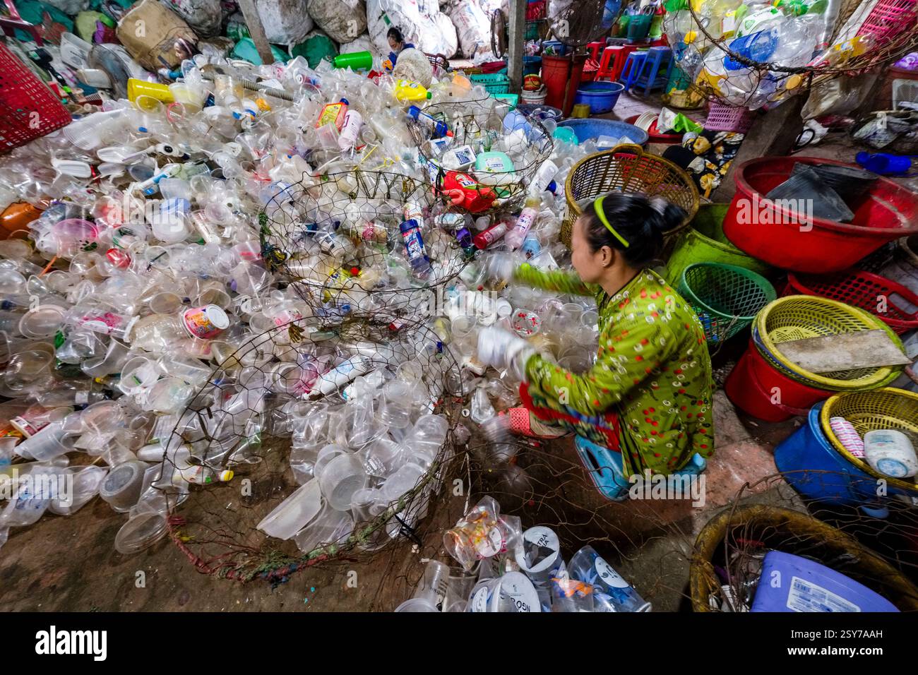 Local women sort plastic waste in a hall in the small village of Tan ...