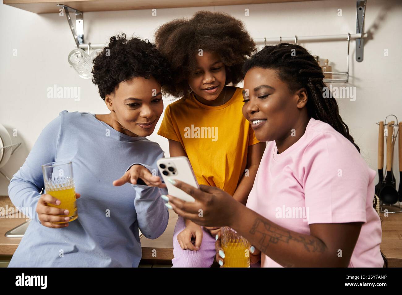 Two loving parents share a delightful moment with their daughter in a ...