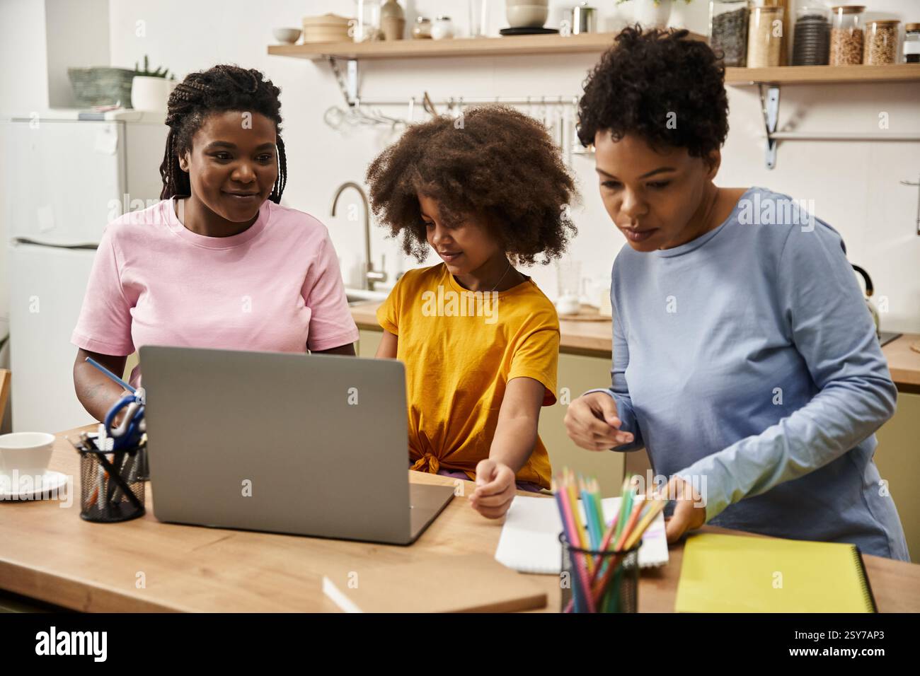 Three family members share a joyful moment in their kitchen, enjoying ...