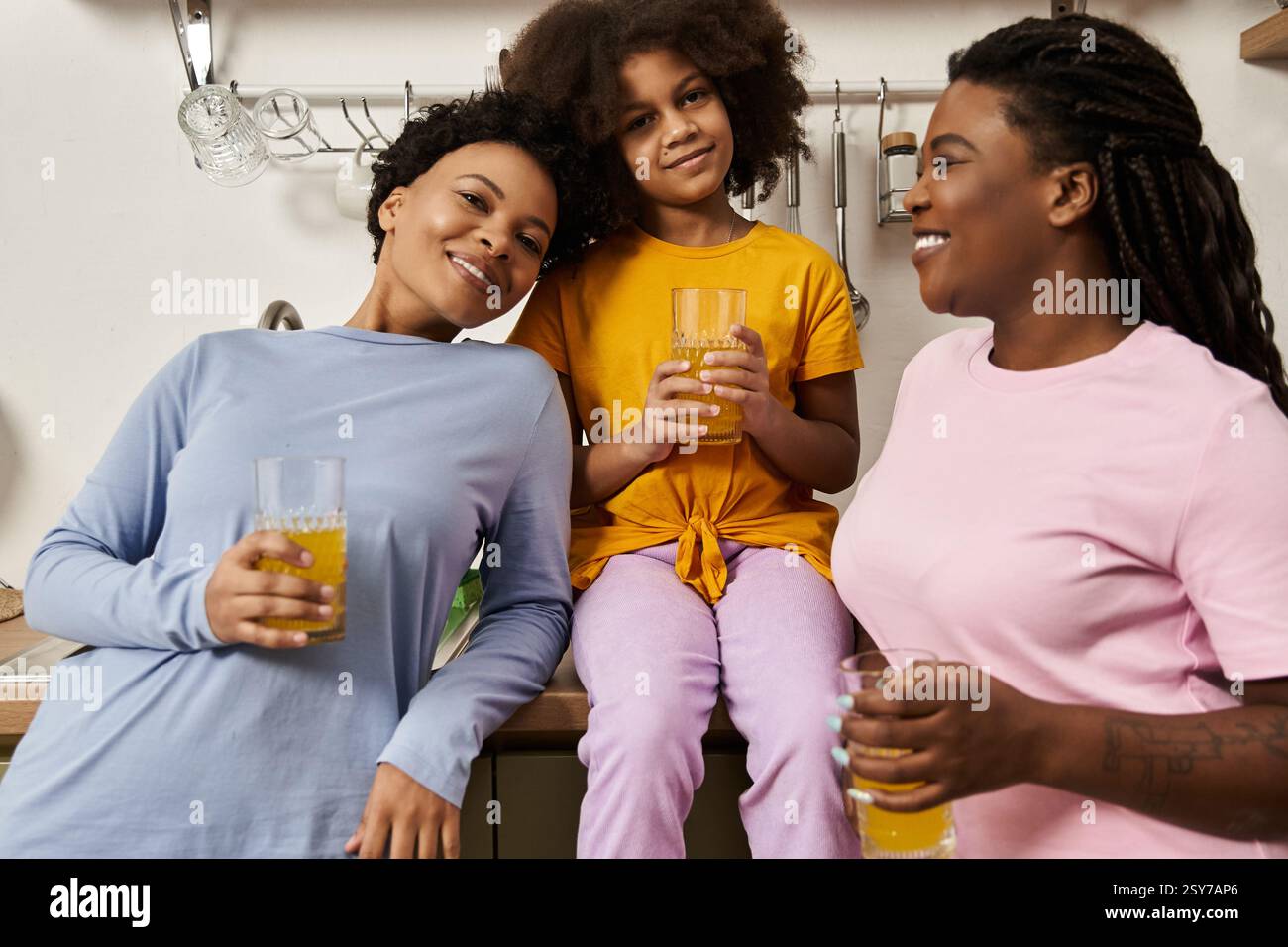 A joyful family shares laughter and bonding over refreshing drinks in a ...