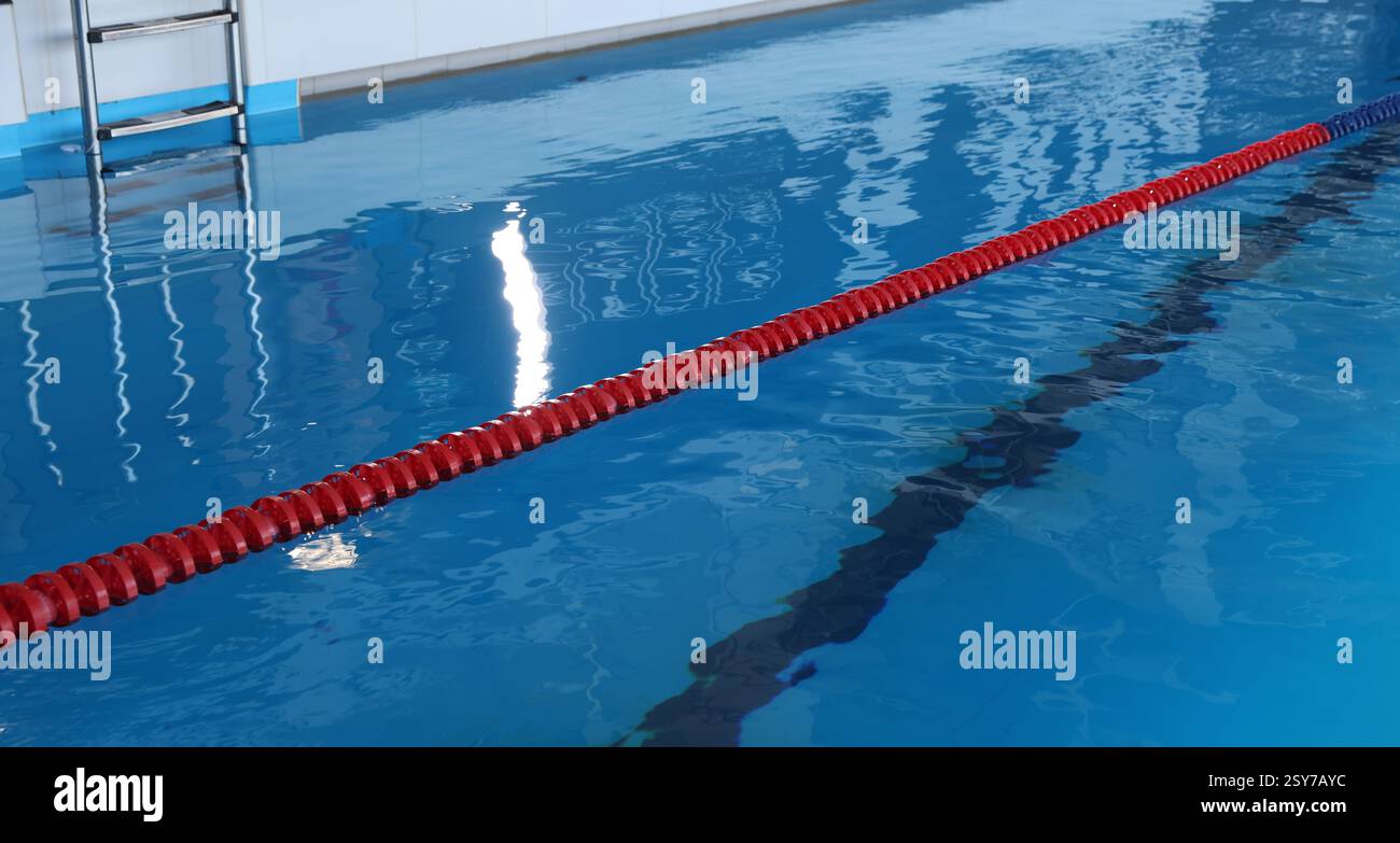 Swimming pool with clean water and lane dividers indoors Stock Photo ...