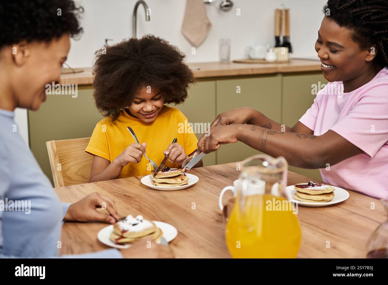 A loving family enjoys a delightful breakfast, sharing laughter and ...
