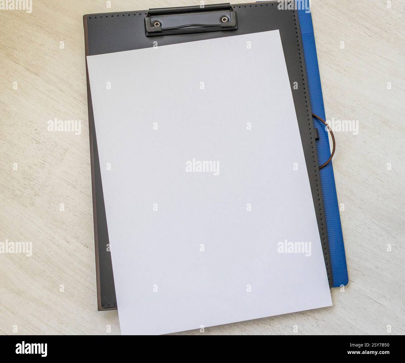 Shot of the plastic folder on the office desk with paper clip holder on ...