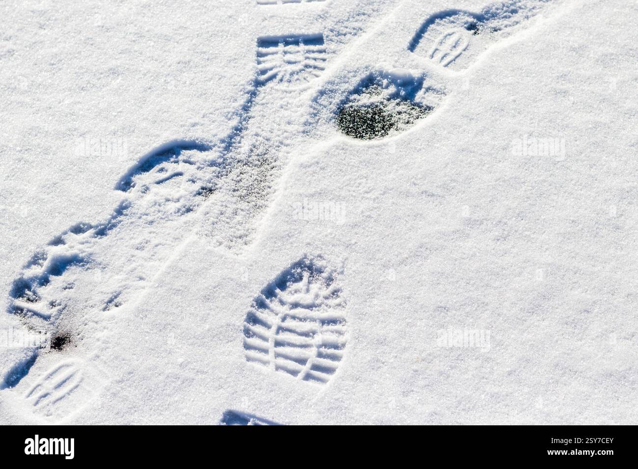 Multiple footprints on the snow Stock Photo - Alamy