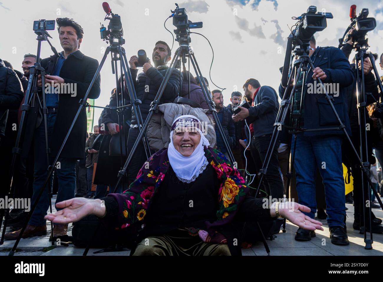 A Kurdish woman gestures as she waits to watch live on a tv screen a Pro-Kurdish Peoples ...
