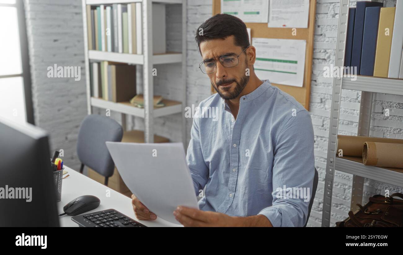 Young hispanic man with beard wearing glasses analyzing document in ...
