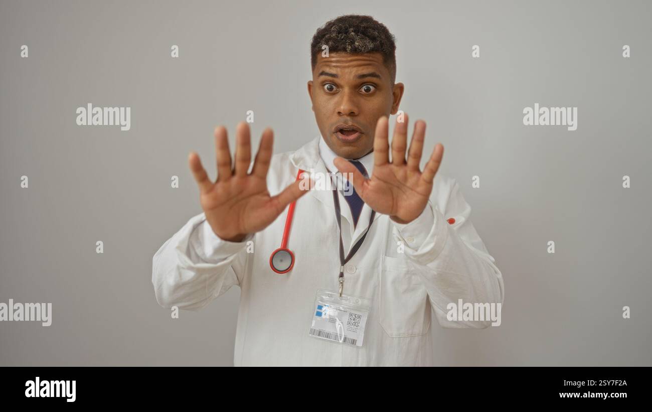Young hispanic man in white lab coat making stop gesture with hands ...