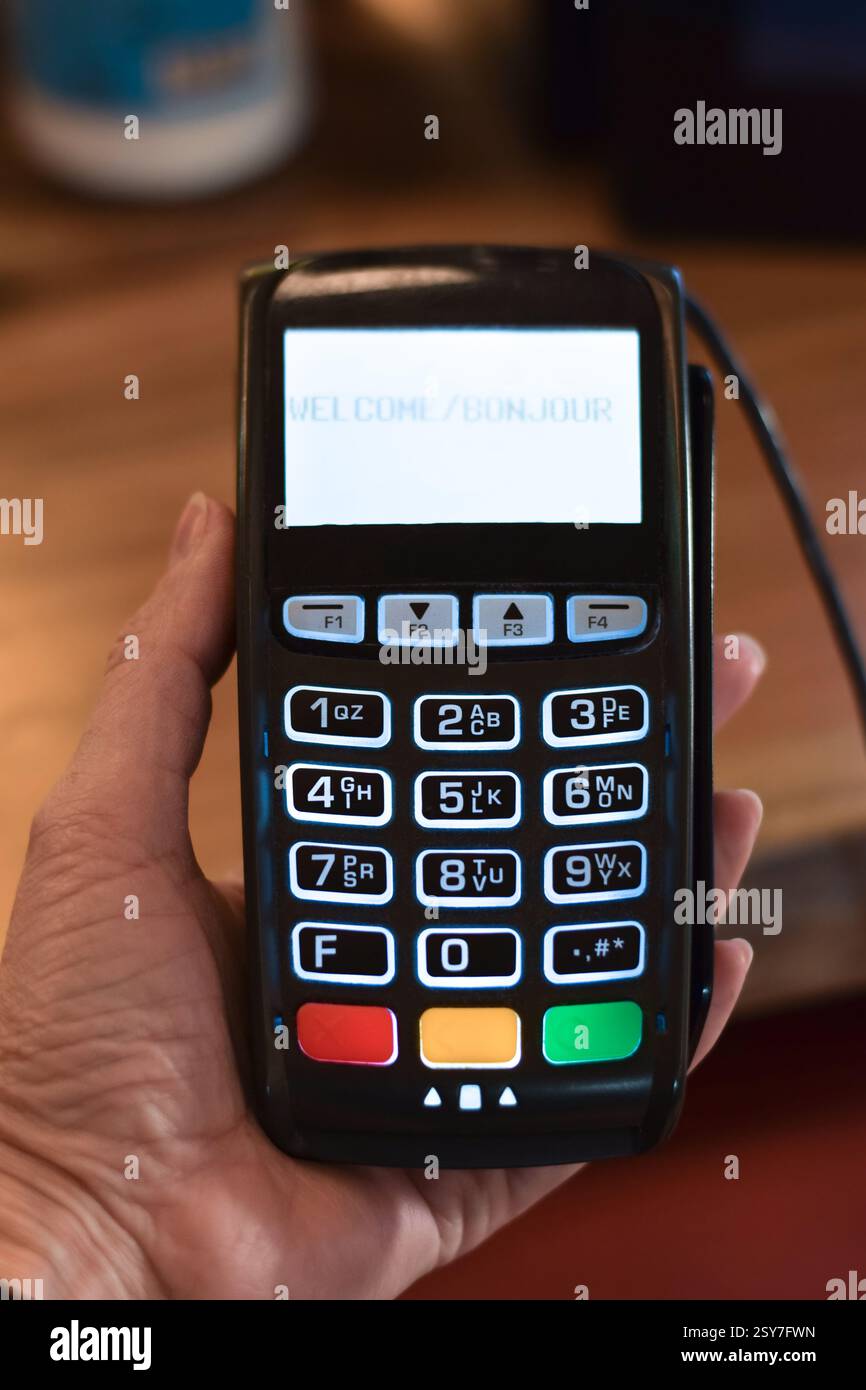 Hand holding payment terminal hi-res stock photography and images - Alamy
