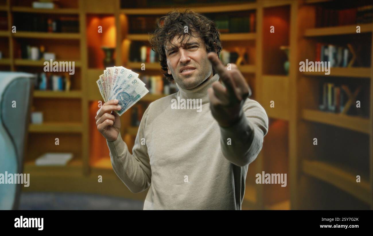 Hispanic man indoors in library showing zloty banknotes with middle ...