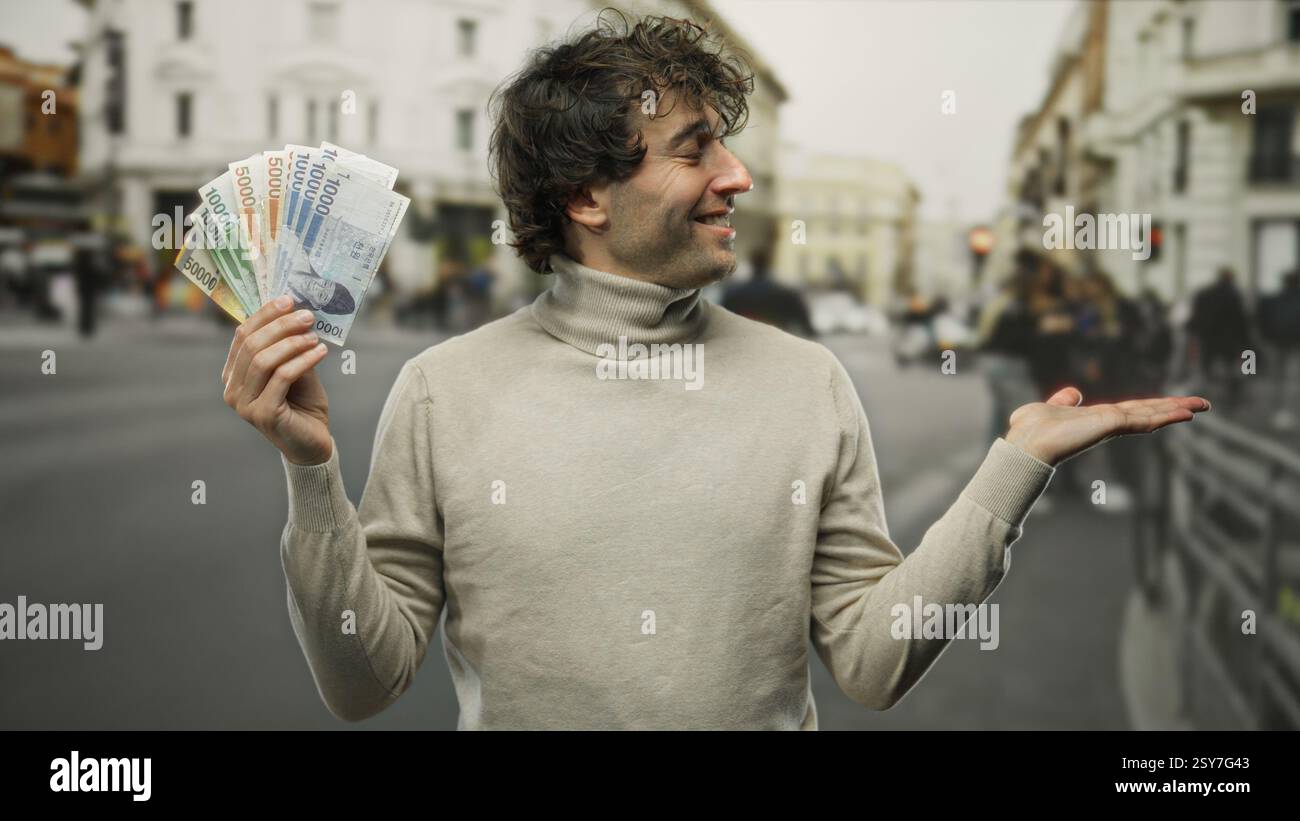 Hispanic man outdoors on city street smiling, holding south korean won ...