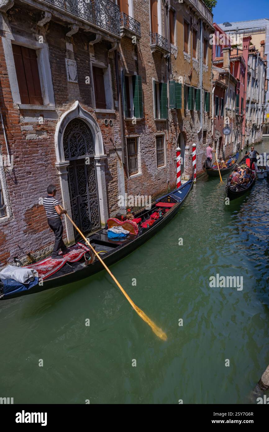 Venice, Italy - July 26, 2024: Gondolier rides gondola on the water ...