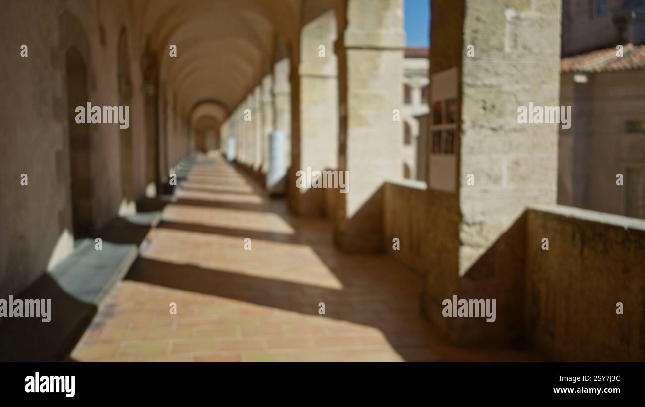 Blurred view of a historic university campus outdoor hallway with ...