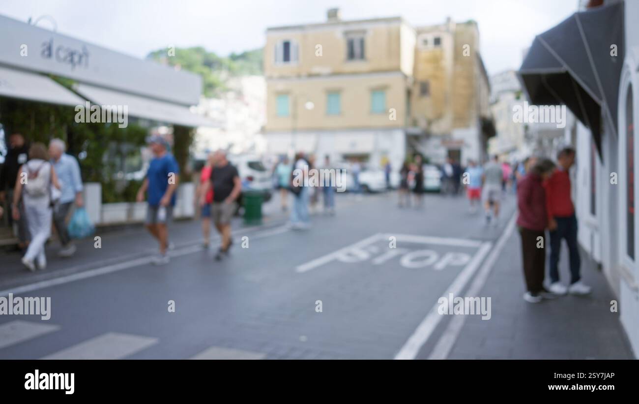 Blurred pedestrians walk along luxury capri street with bokeh ...
