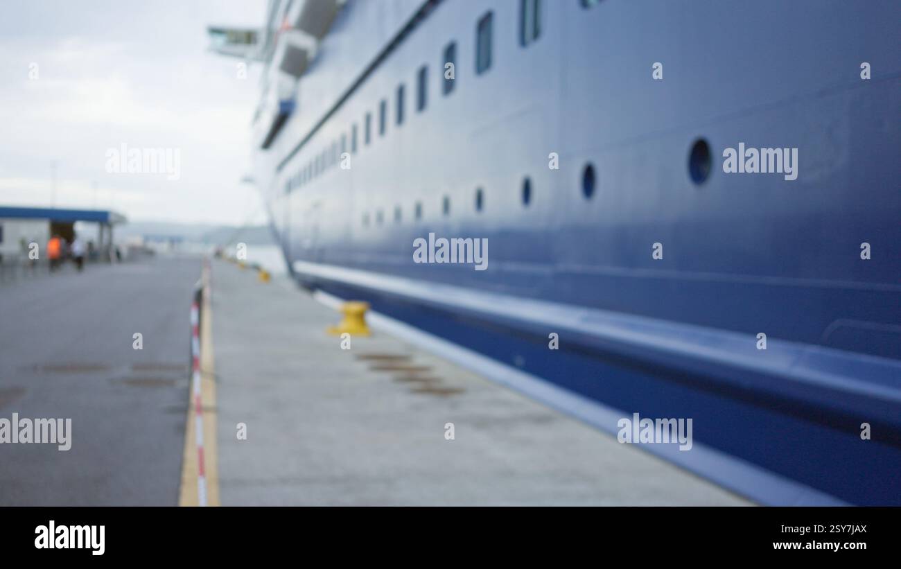 Blurred view of a massive cruise ship docked at an outdoor port with ...